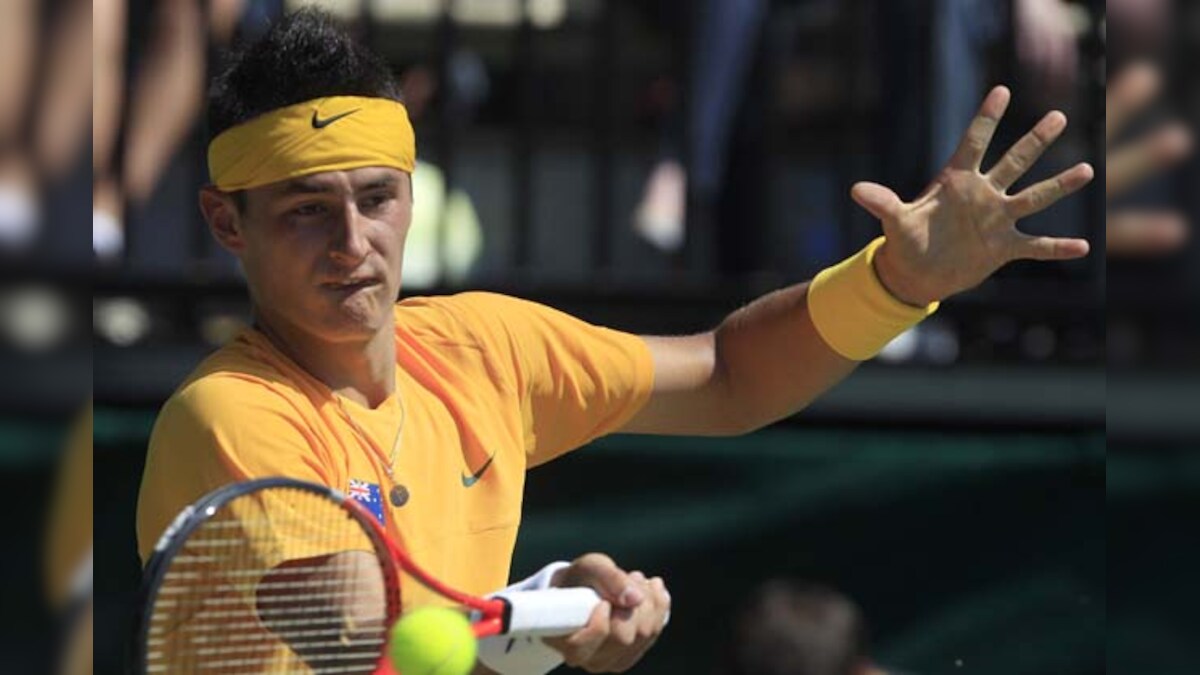 Tomic advances to round three after tough win