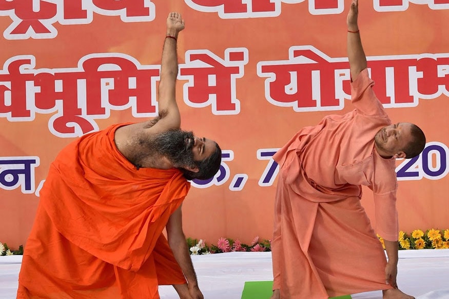 Yogi Adityanath performs yoga with Baba Ramdev - News18