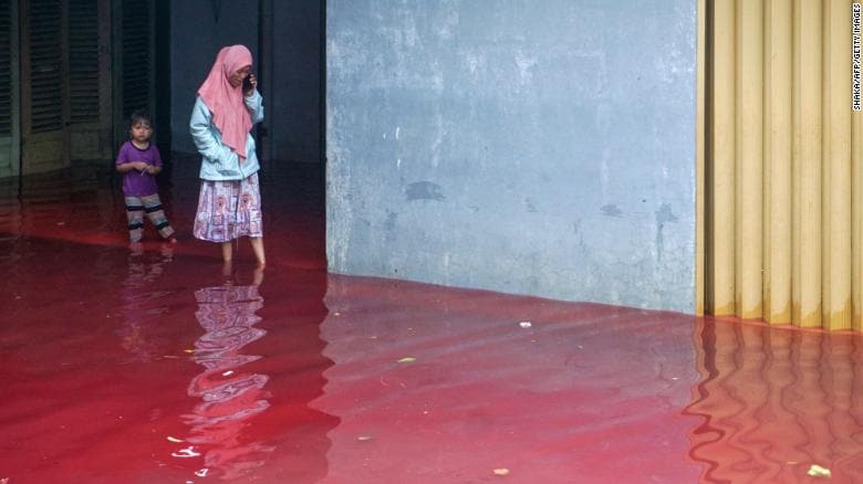 In Photos: Red Flood Turns Indonesian Village Surreal after Water ...