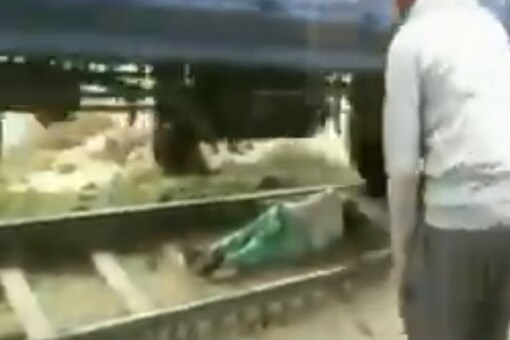 Woman Lays Still on Railway Track to Escape being Crushed by Train in ...