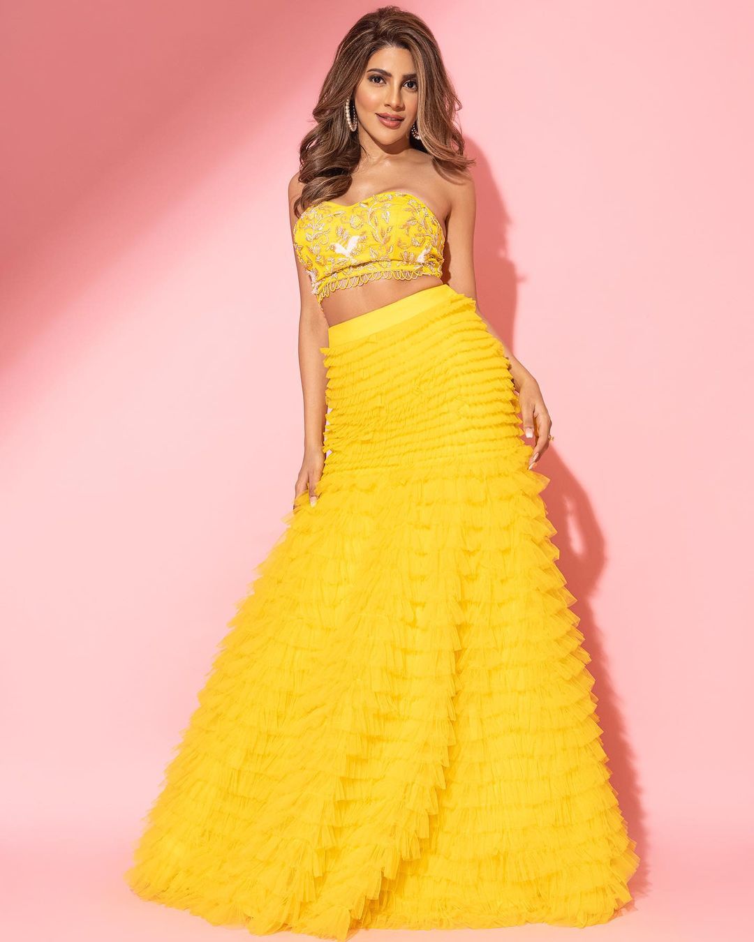 Nikki Tamboli Gives Bombshell Vibes In Pink Ruffled Saree With Deep ...