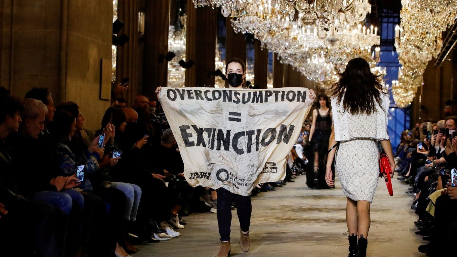 Climate Change Protester Disrupts Fashion Show in Paris, Walks Holding ...