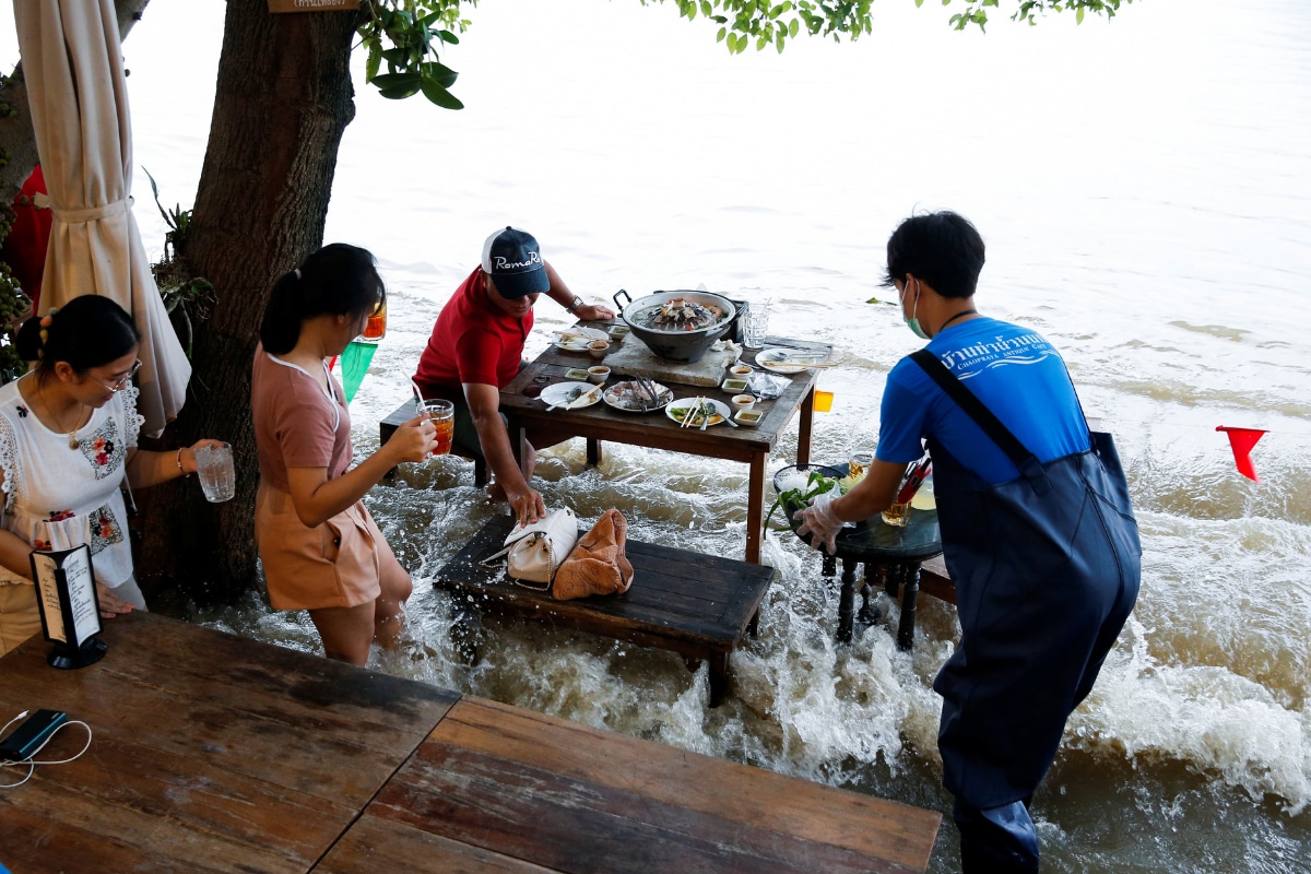 In Photos: Riverside Restaurant in Thailand Hosts Customers as Flood ...