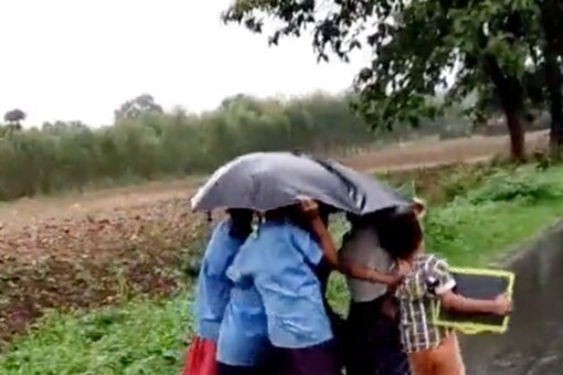 WATCH: Video of Children Sharing One Umbrella Leaves Internet Nostalgic ...