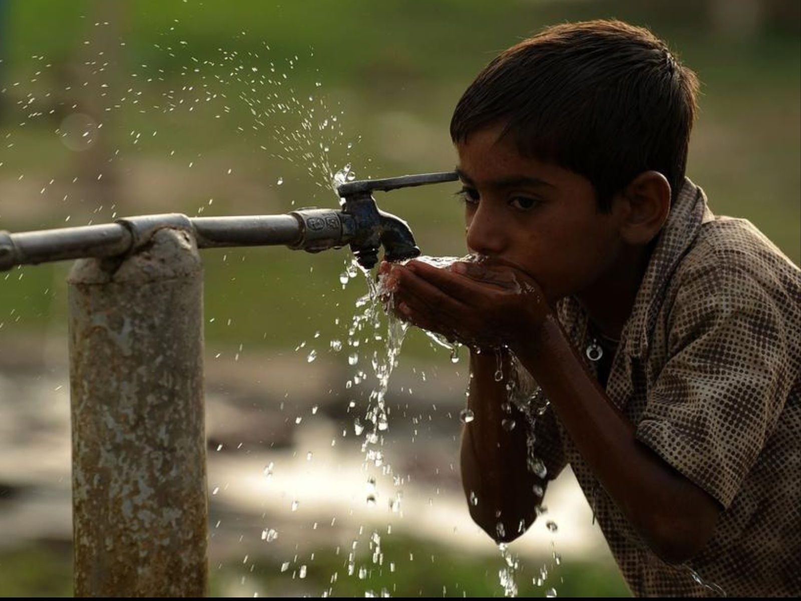 Poor Kid Drinking Water