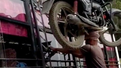 'Real Bahubali': Man Climbs Bus With Motorbike on His Head | Buzz News ...