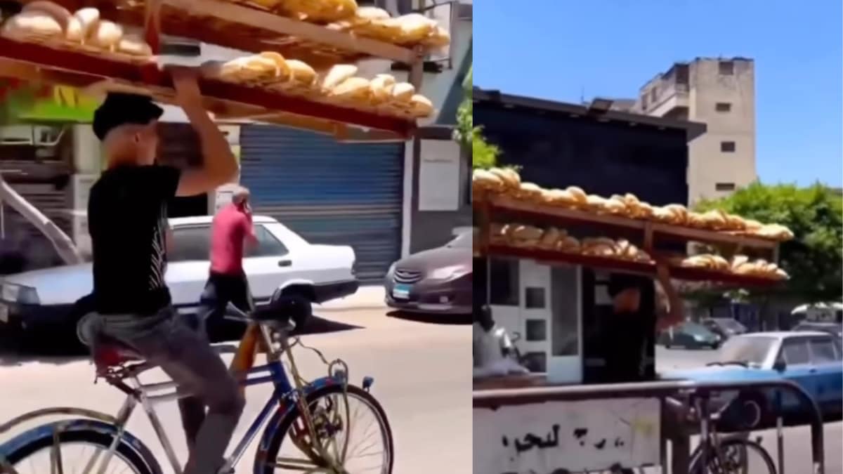Cyclist Balances Multiple Trays Of Bread On Head While Riding Through ...
