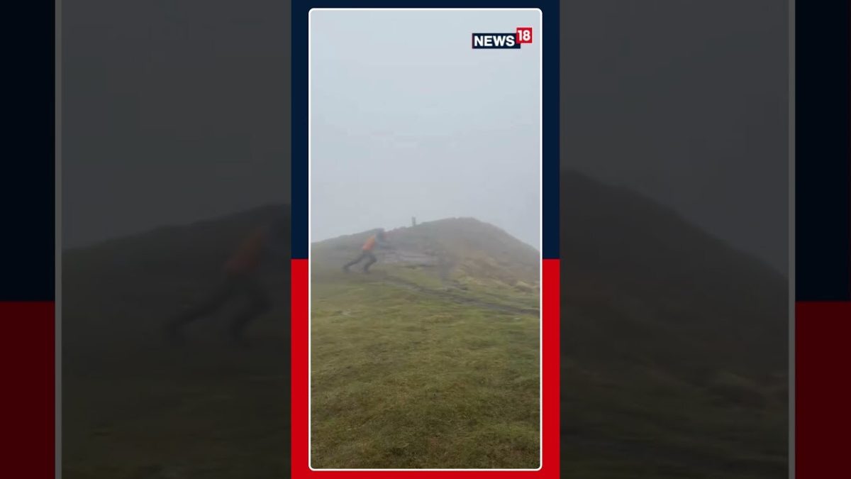 A man was seen leaning hard into the wind while attempting to walk against extreme gusts | N18S