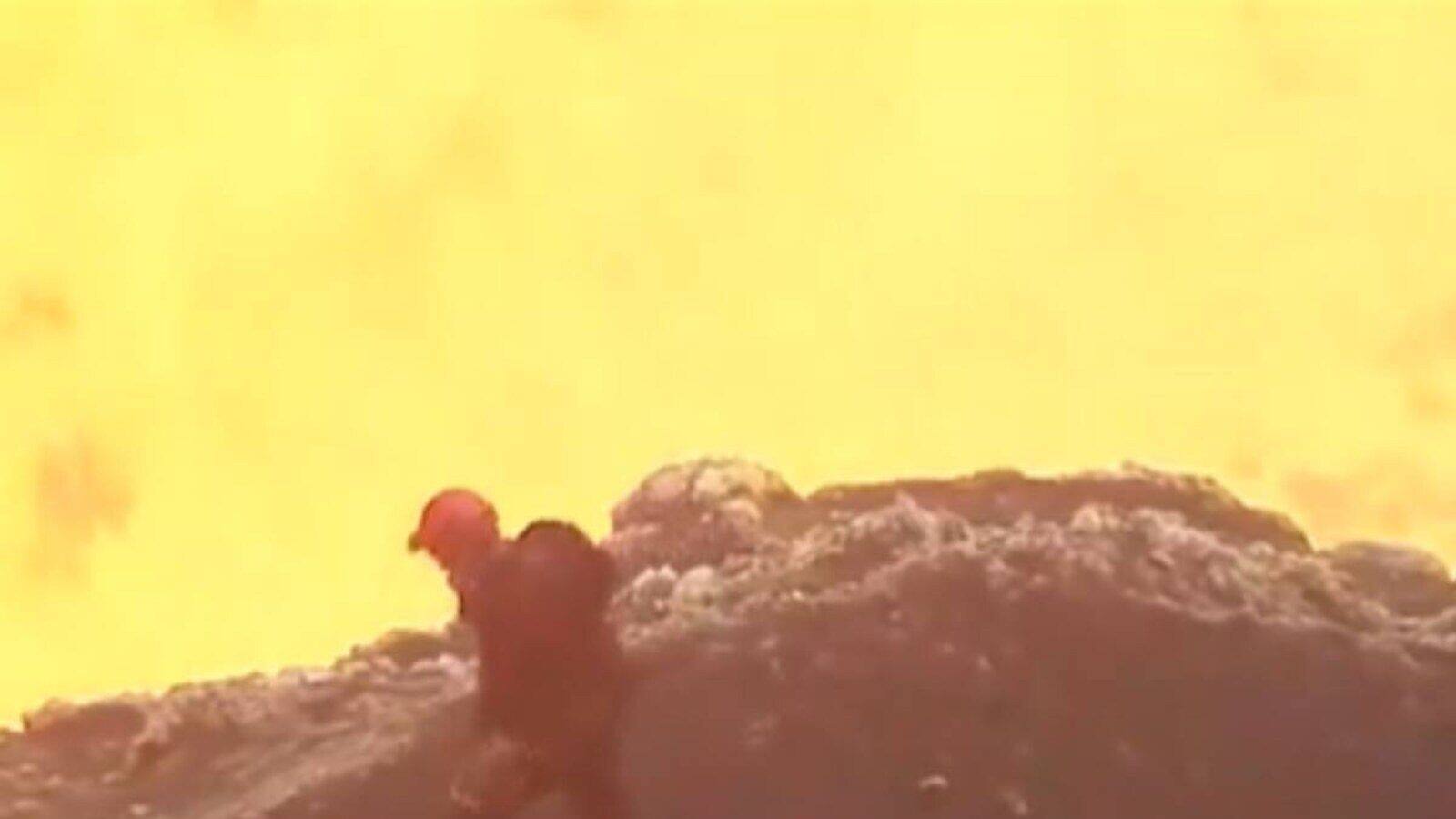 viral video of man standing on the edge of lava ocean people shocked to ...